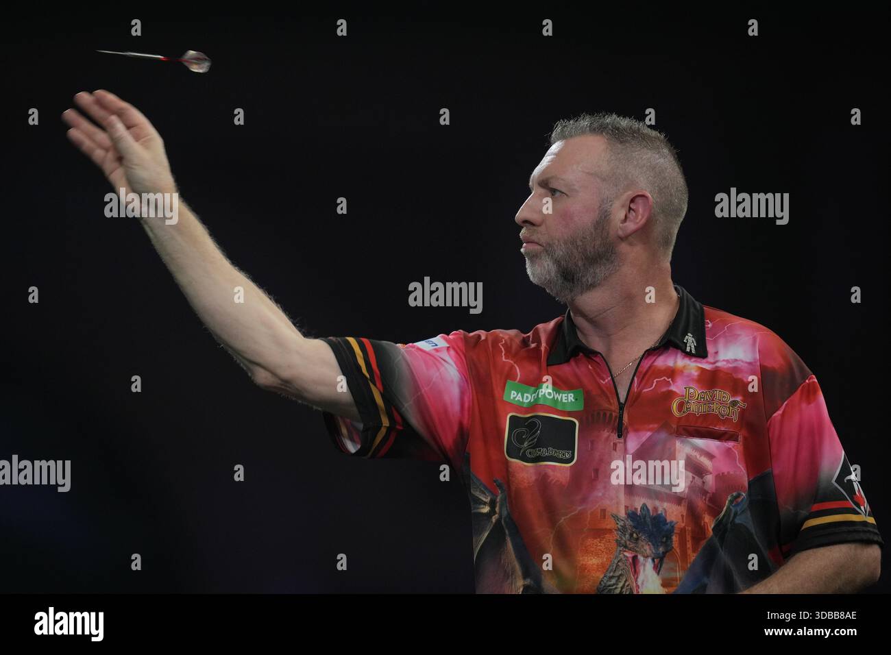 David Cameron of Canada throws a dart as he takes part in a round one ...