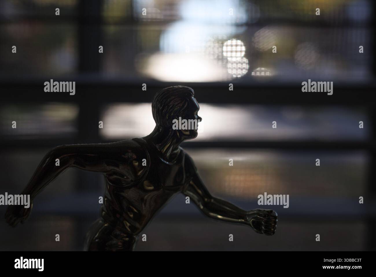 Detail of a track trophy of a running man silhoutted in front of a ...
