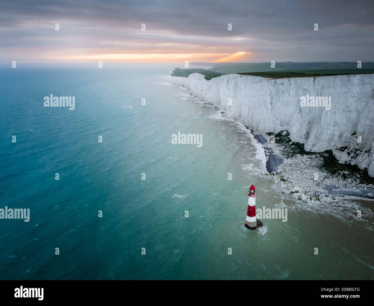 Aerial view of the iconic Beachy Head Lighthouse standing resilient ...