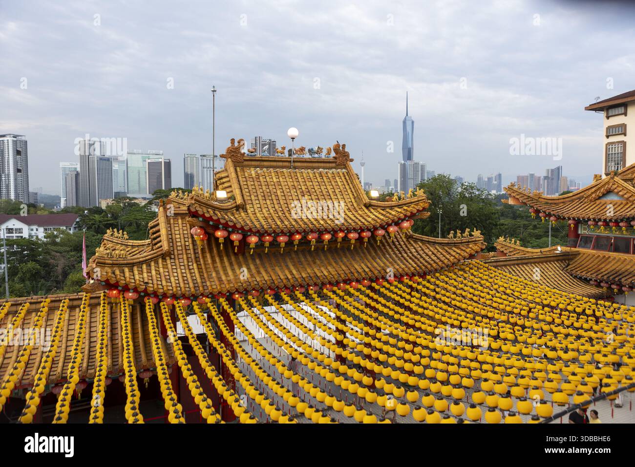 View of golden temple roofs adorned with strings of lanterns juxtapose ...