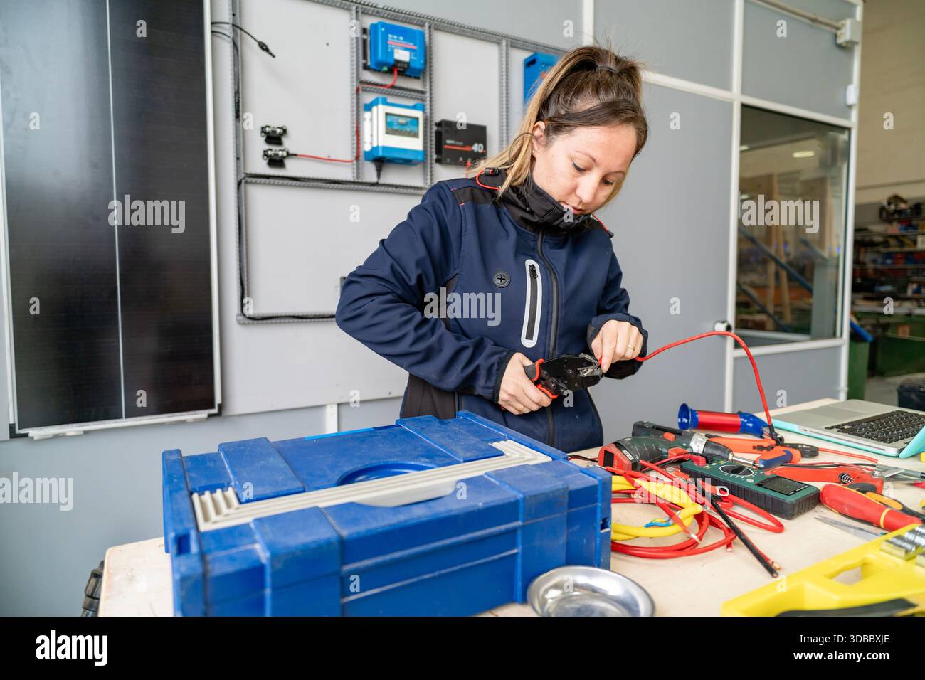 Woman linking solar panel hi-res stock photography and images - Alamy