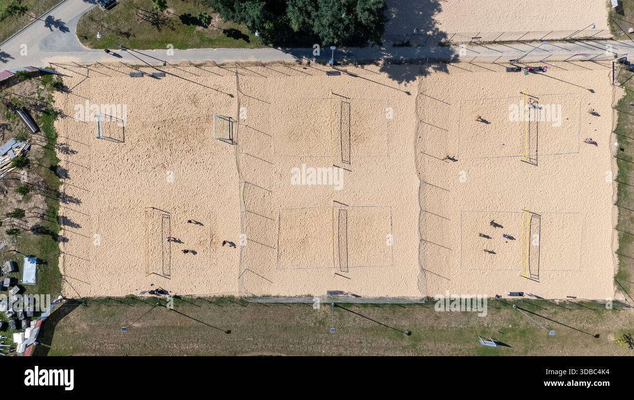 Aerial view of multiple sand volleyball courts with players Stock Photo ...