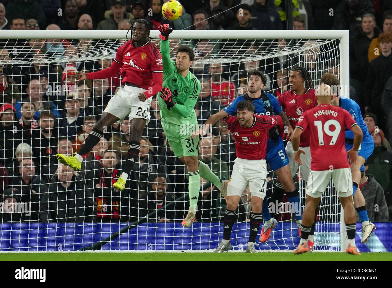 Manchester United's goalkeeper Senne Lammens punches out the ball ...