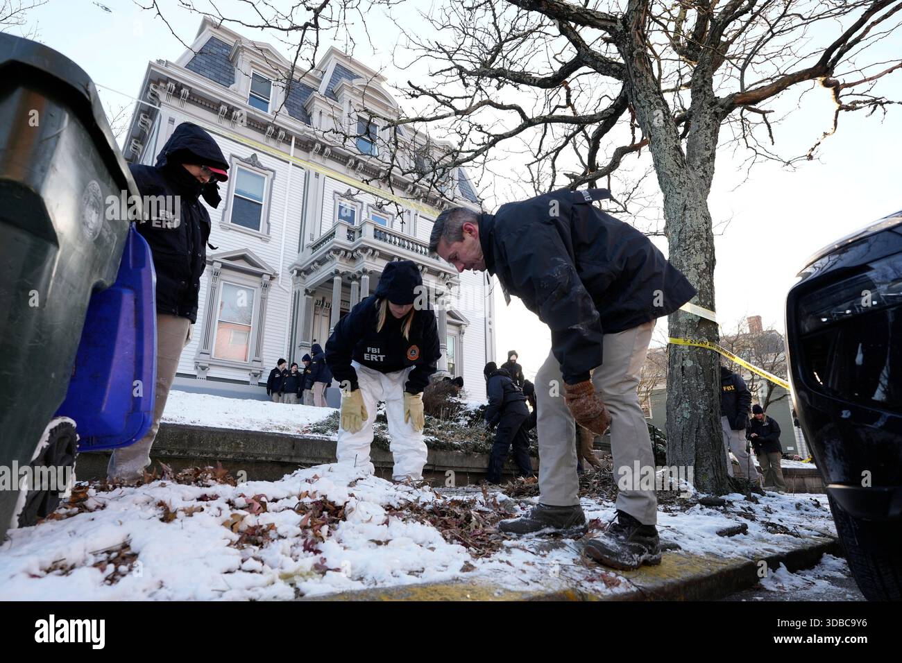 Members of the FBI Evidence Response Team search for evidence near the ...
