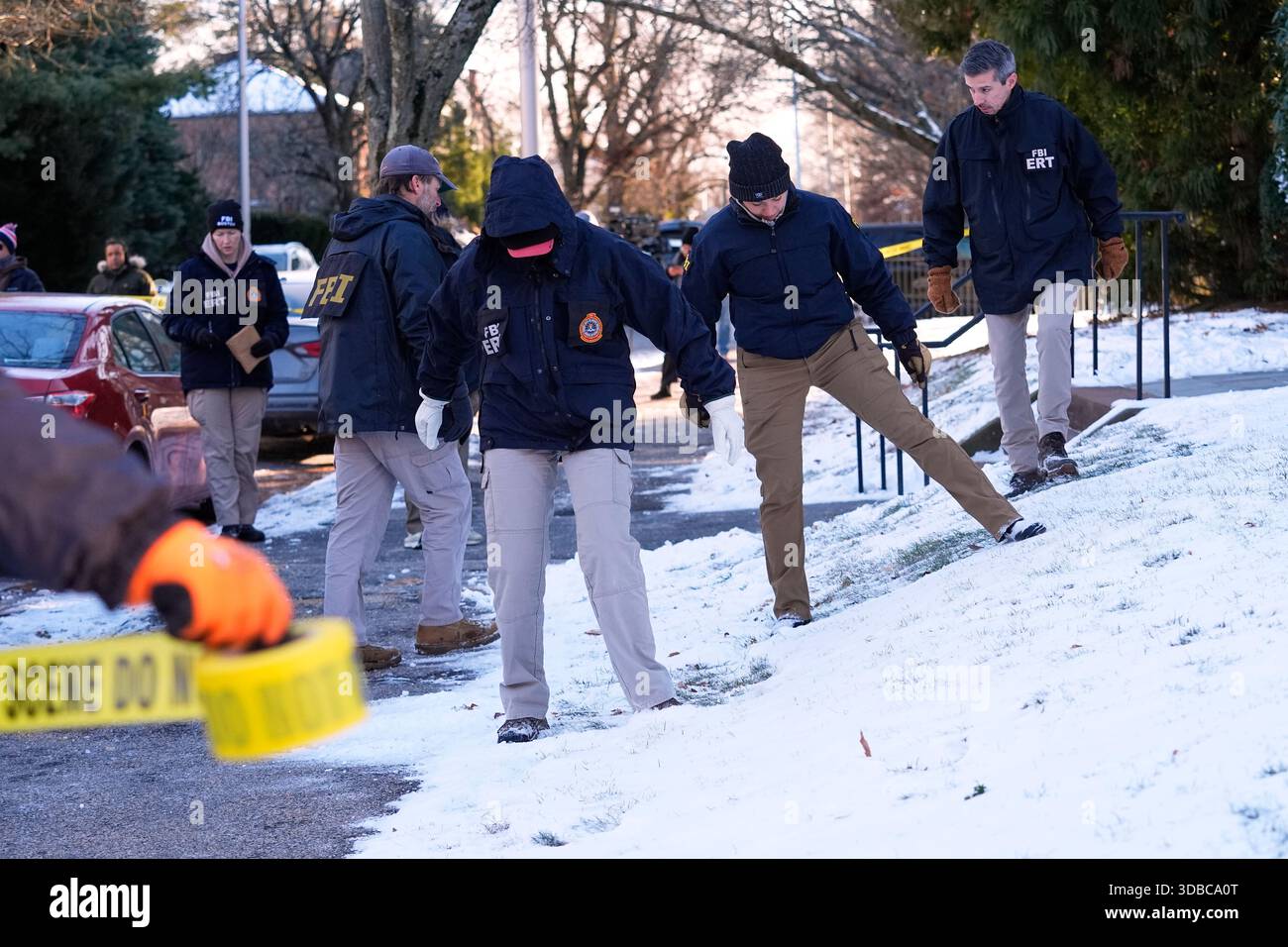 Members of the FBI Evidence Response Team search for evidence near the ...