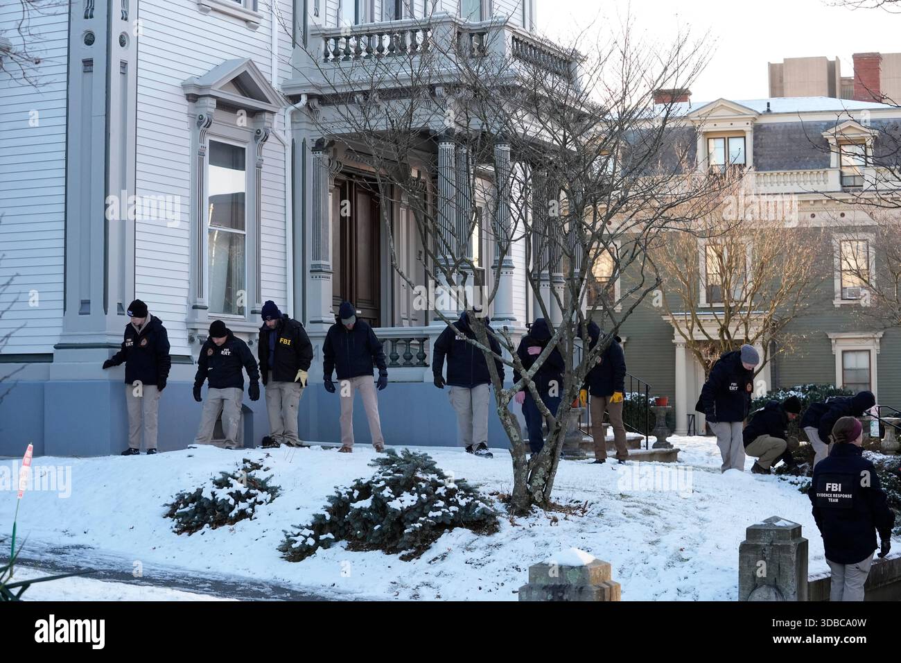 Members of the FBI Evidence Response Team search for evidence near the ...