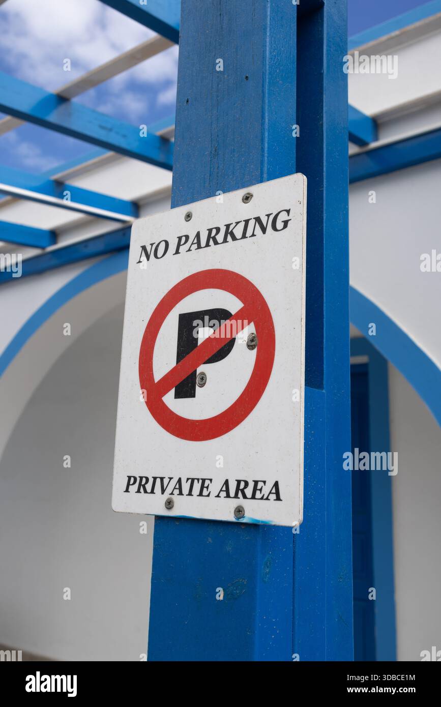 No Parking private area sign on a blue and white structure in Santorini ...
