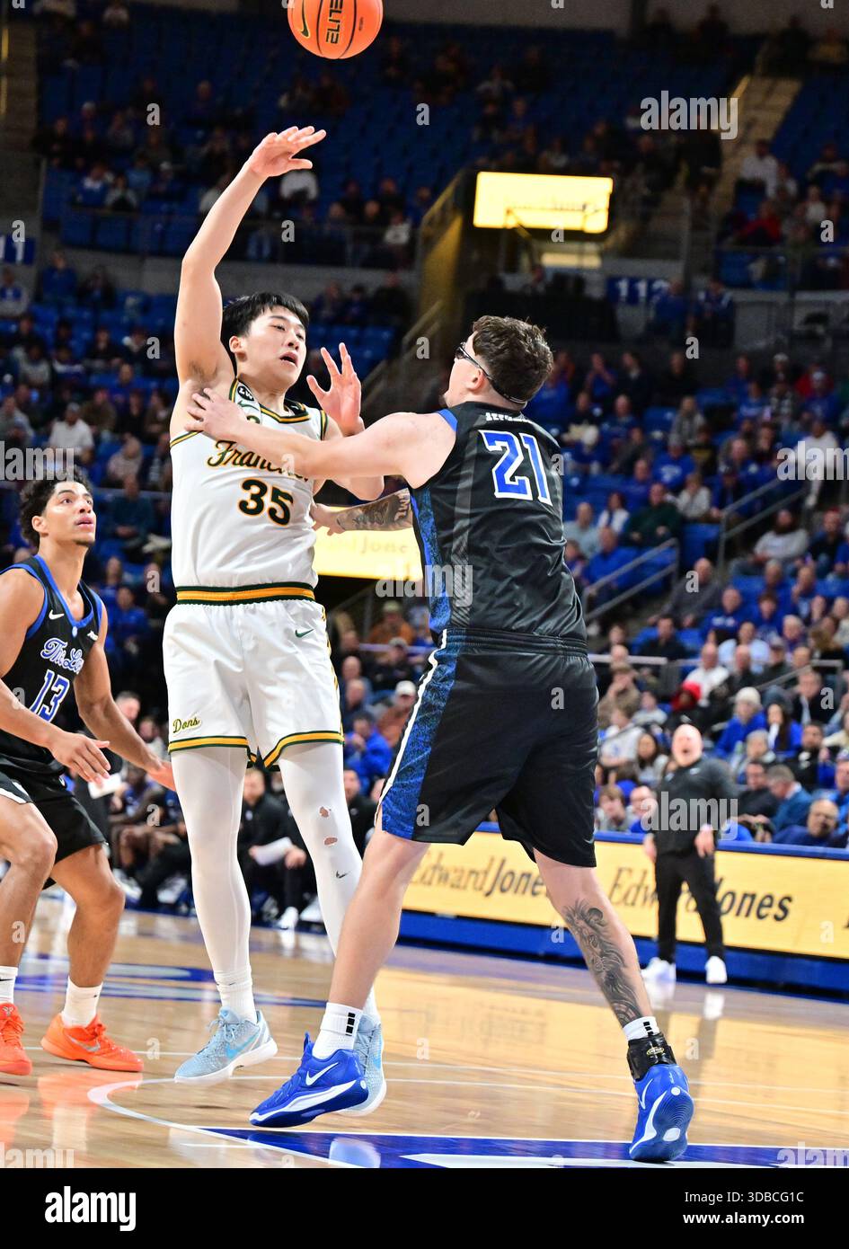 ST. LOUIS, MO - DECEMBER 13: San Francisco forward Junjie Wang (35) puts up a shot as Saint ...