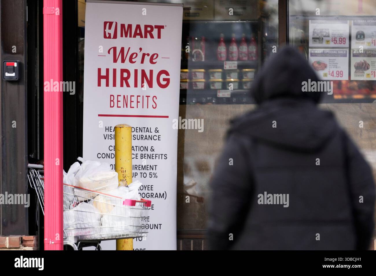 Hiring sign is displayed at a grocery store, in Glenview, Ill., Monday ...