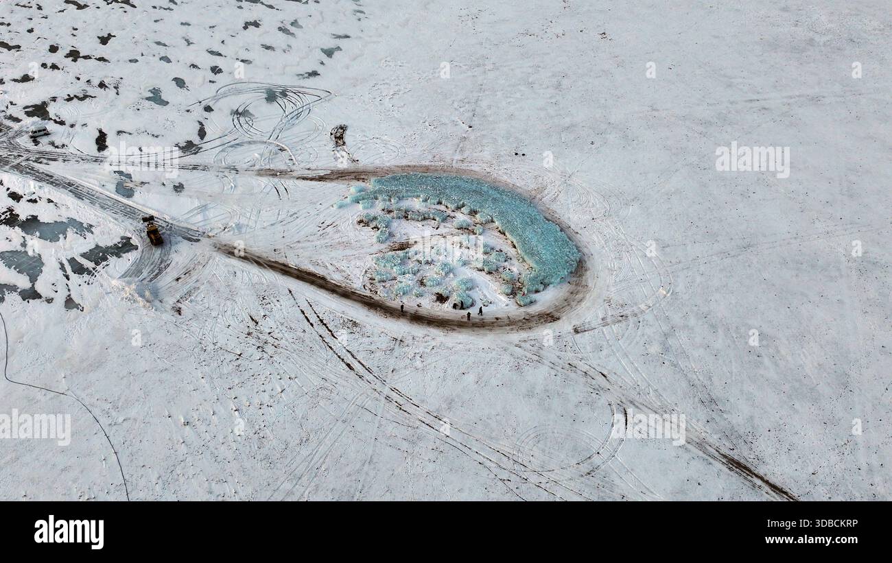 BARKOL, CHINA - DECEMBER 14, 2025 - Workers use ice saws to cut the ...