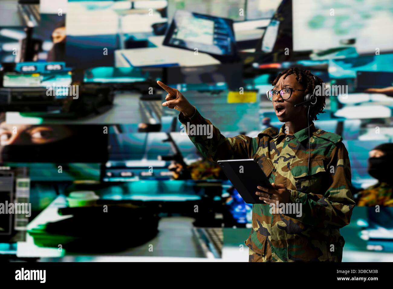 Shocked army dispatcher soldier in camouflage gasps while pointing to ...