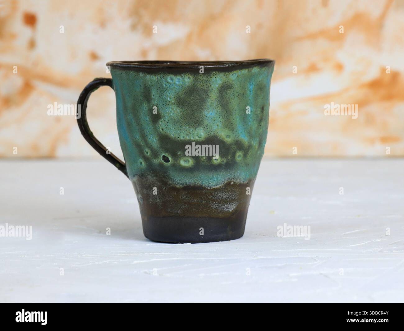 Single ceramic mug with visible glaze defects from firing. The surface ...