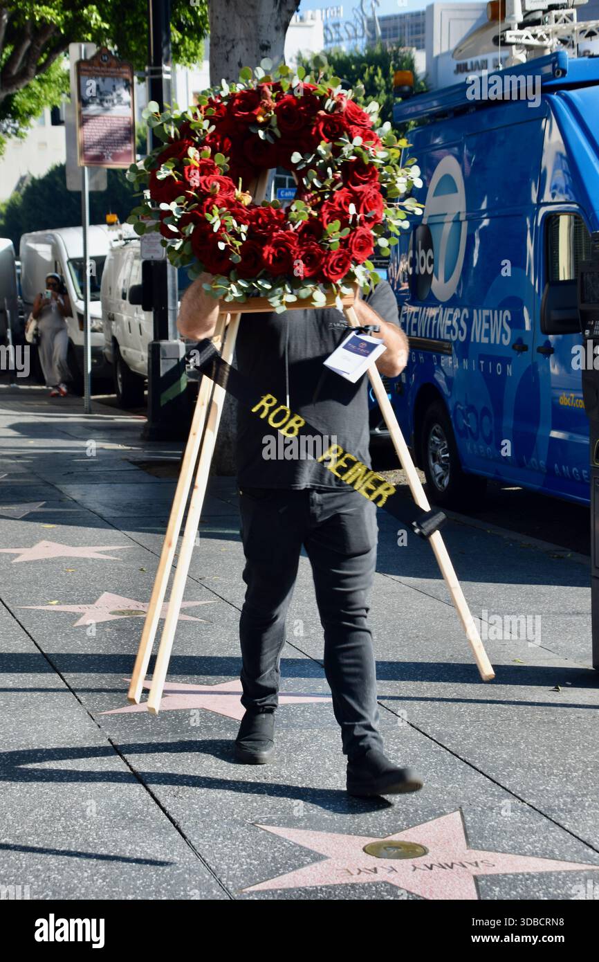A flower delivery man places a memorial wreath on the Hollywood Walk of ...