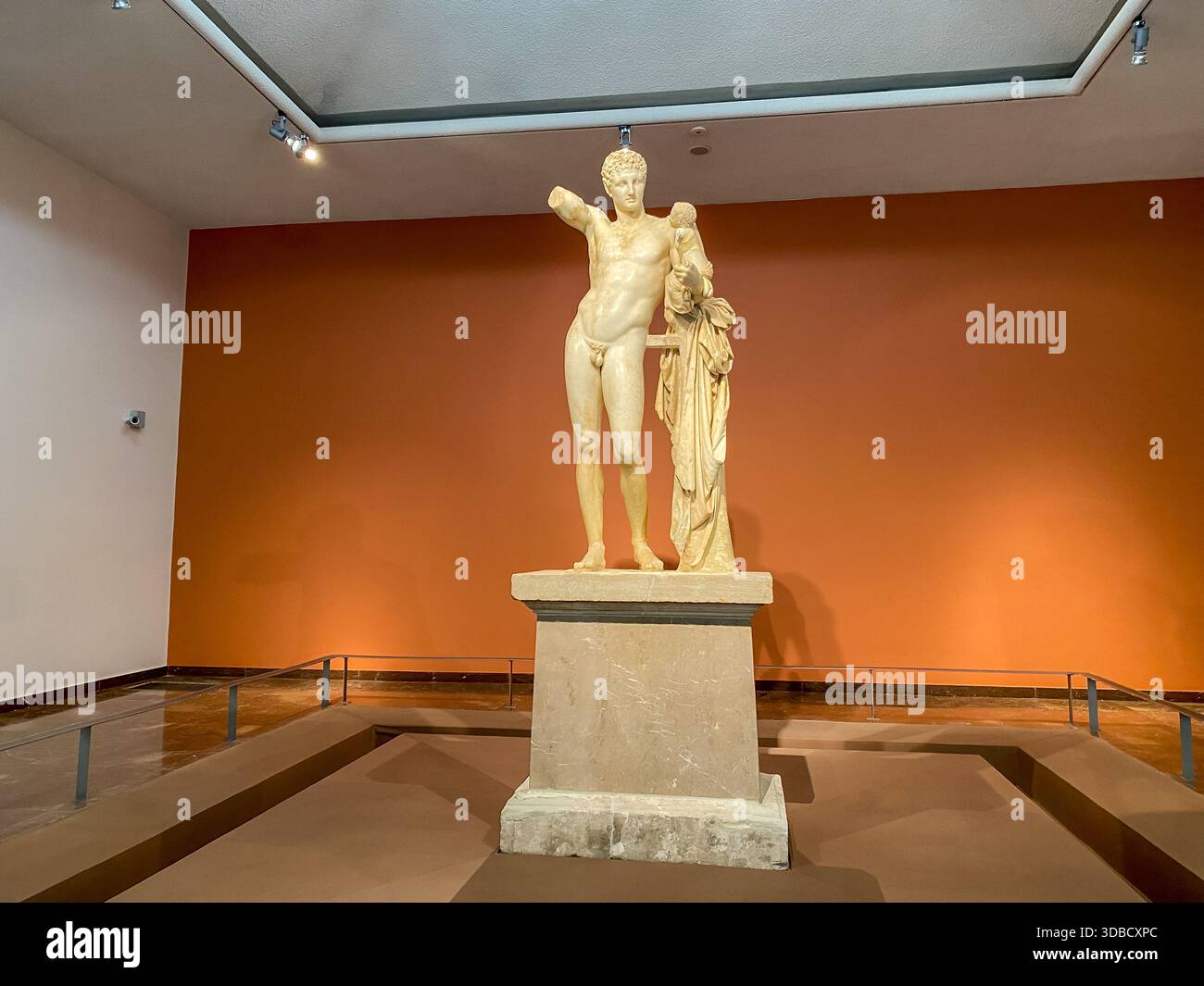 Statue of Hermes with the infant Dionysus displayed inside the Olympia ...