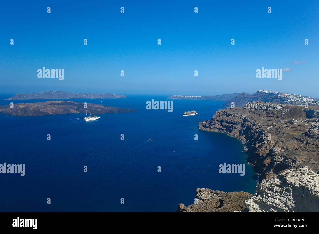 Cruise ships anchored inside the volcanic caldera of Santorini, Greece ...