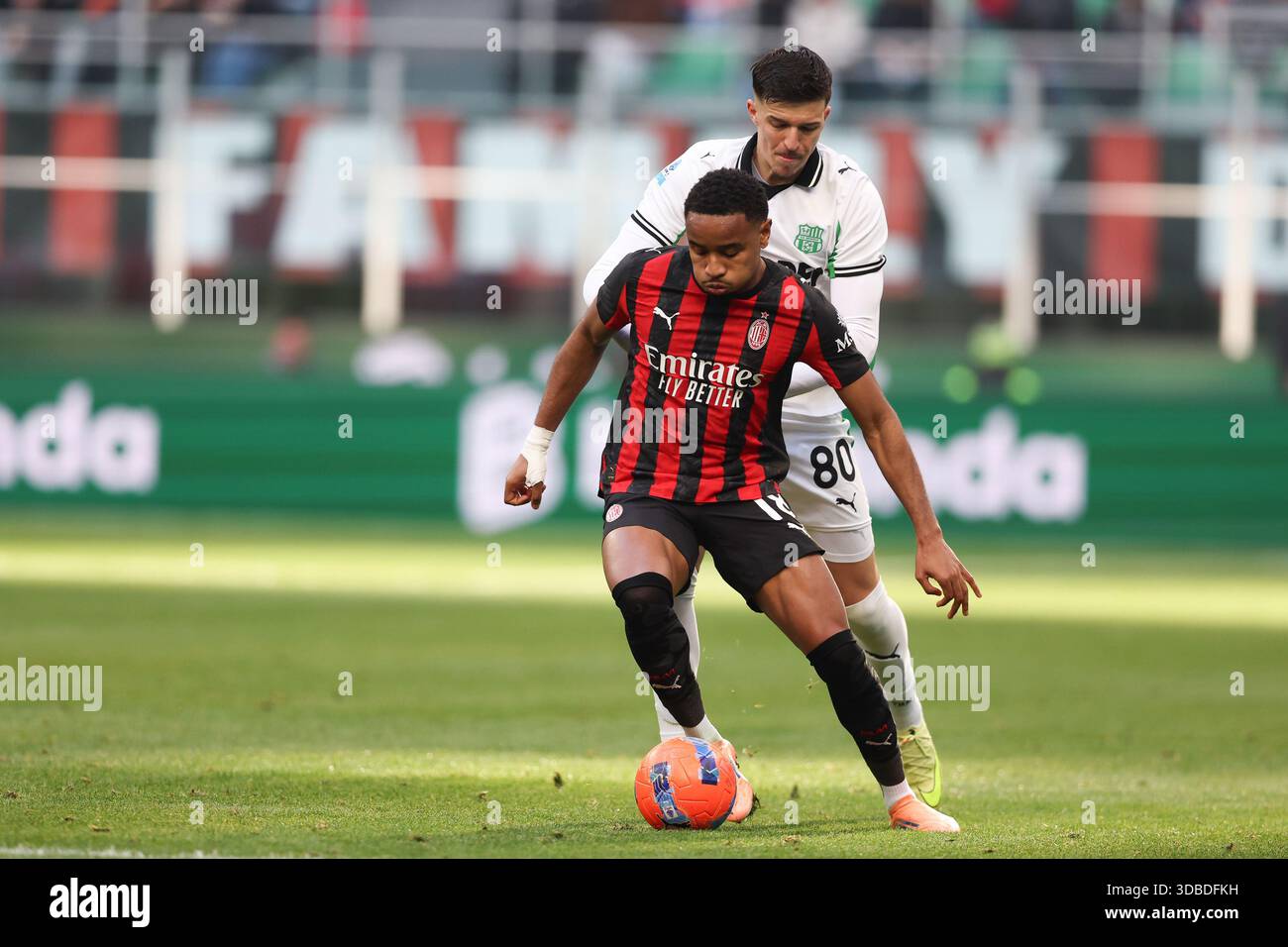 Christopher Nkunku of AC Milan (L) and Tarik Muharemovic of Sassuolo ...