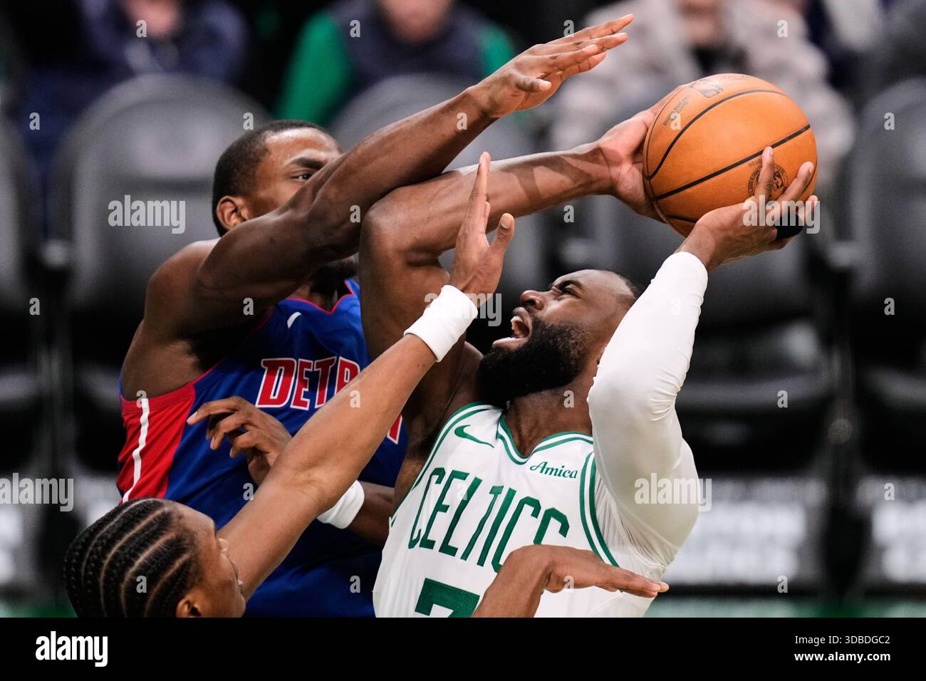 Boston Celtics guard Jaylen Brown, right, is covered by Detroit Pistons ...