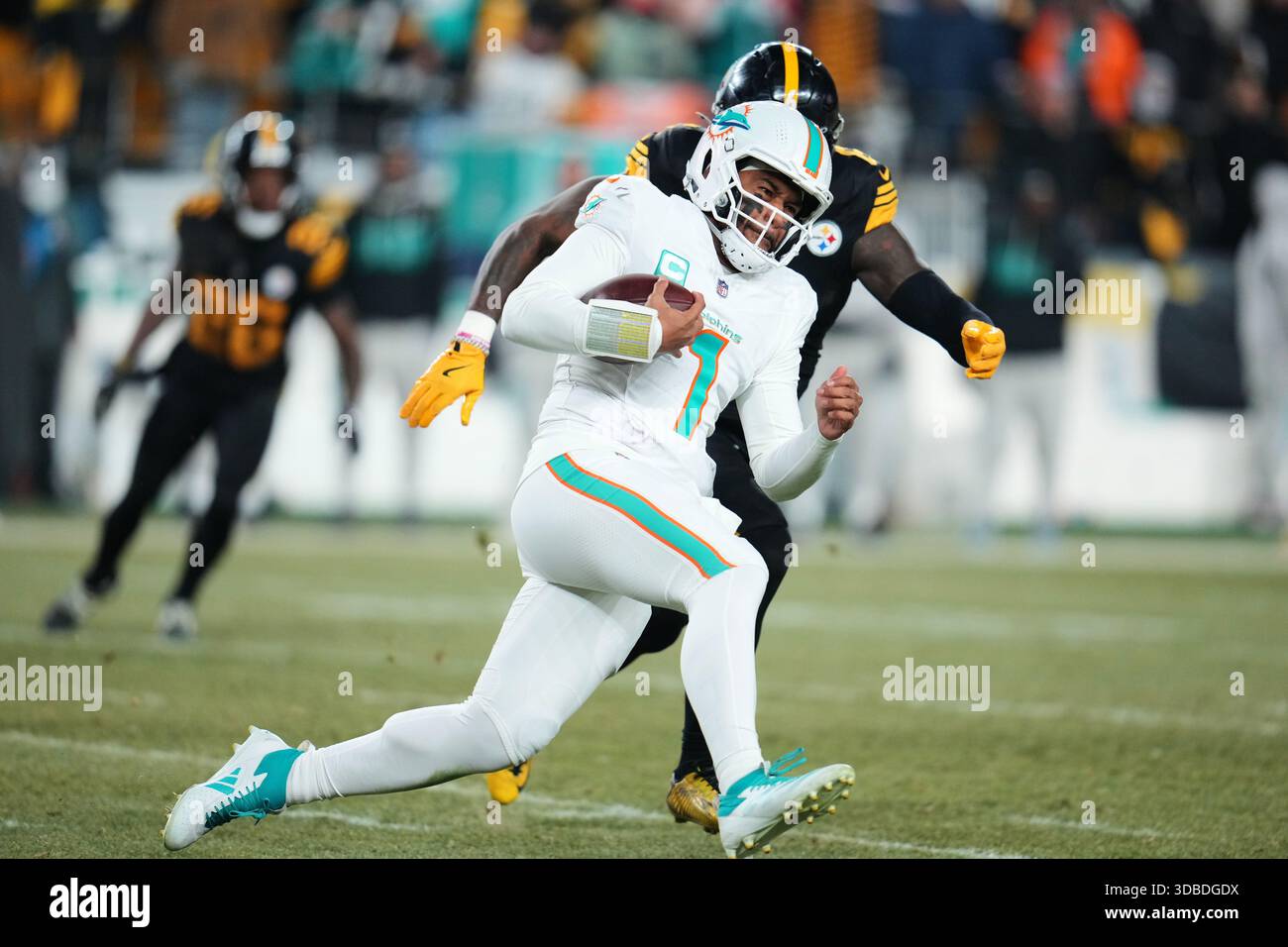 Miami Dolphins quarterback Tua Tagovailoa (1) carries the ball as ...