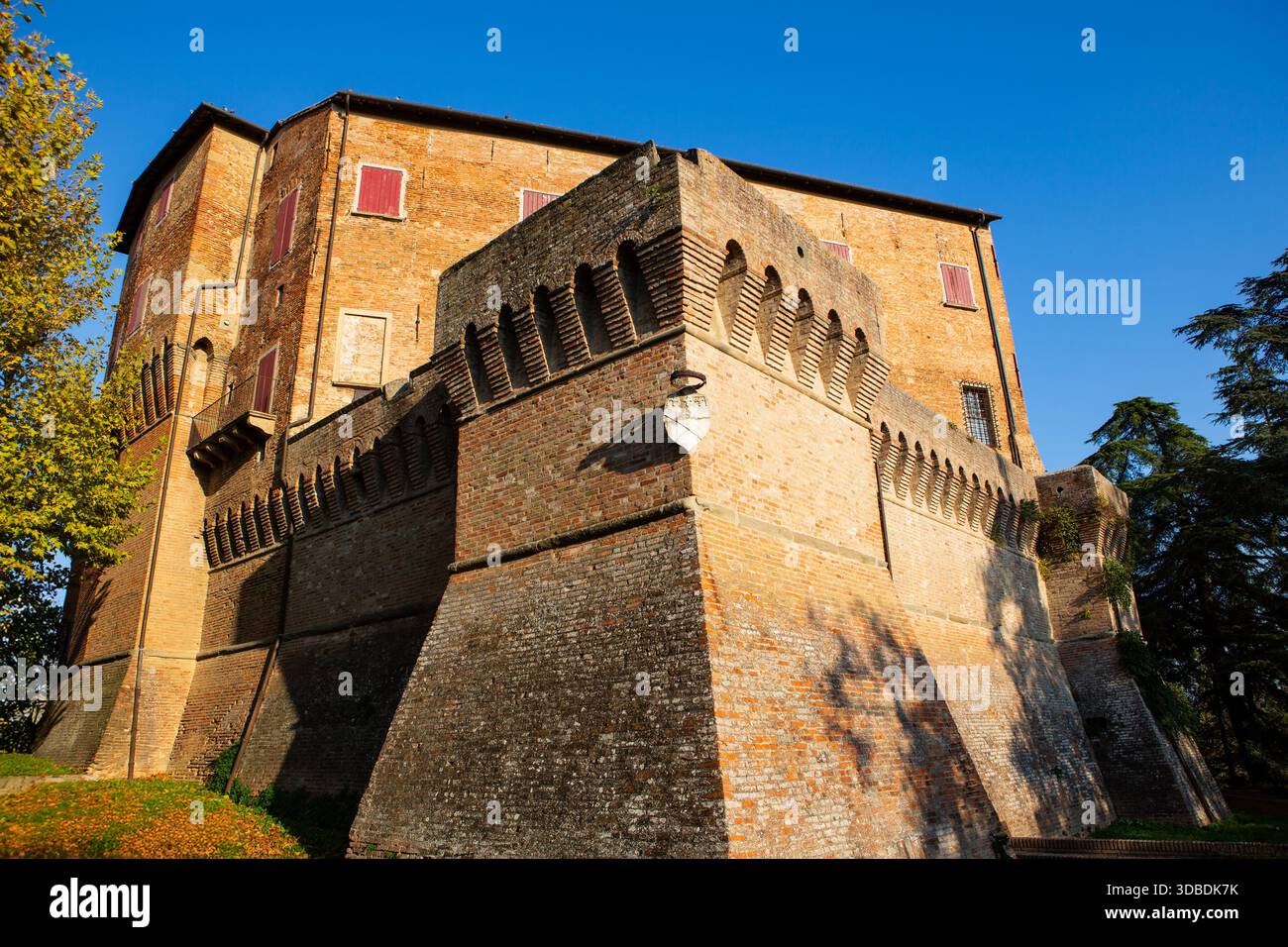 Majestic medieval fortress photographed from below showing red shutters ...