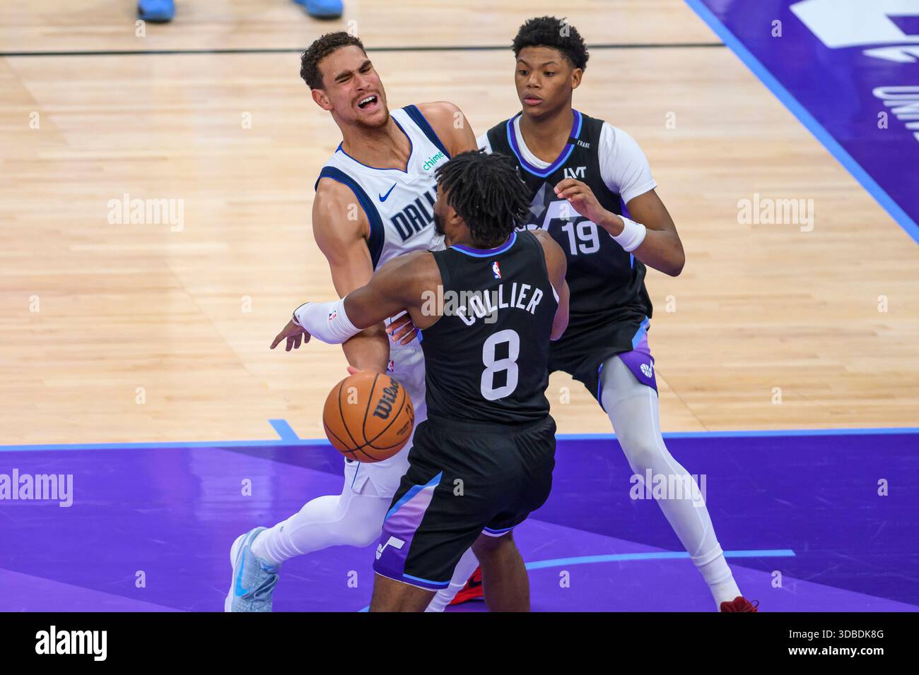 Dallas Mavericks forward Dwight Powell, back left, is fouled by Utah Jazz guard Isaiah Collier ...