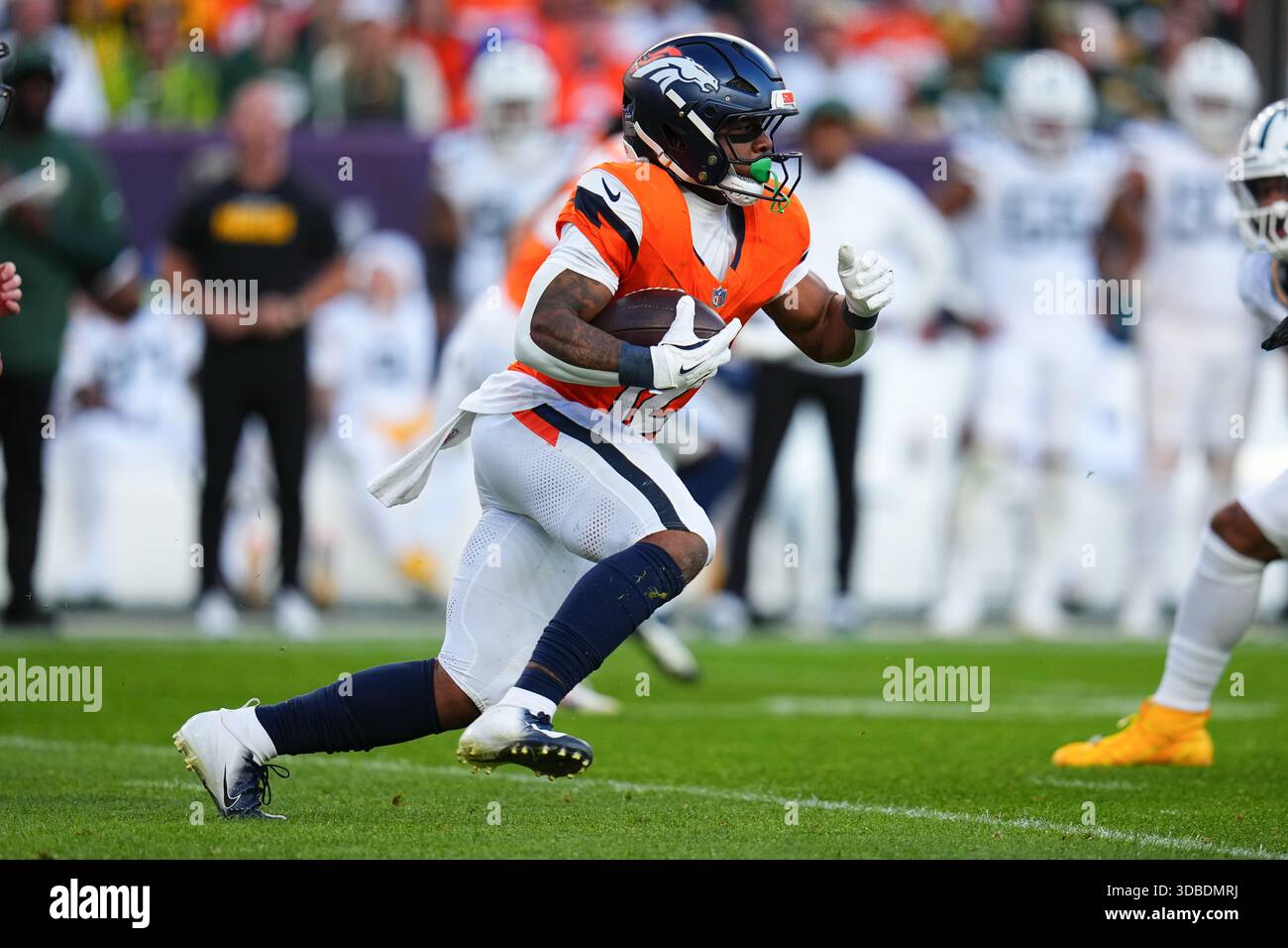Denver Broncos running back RJ Harvey (12) runs against the Green Bay ...