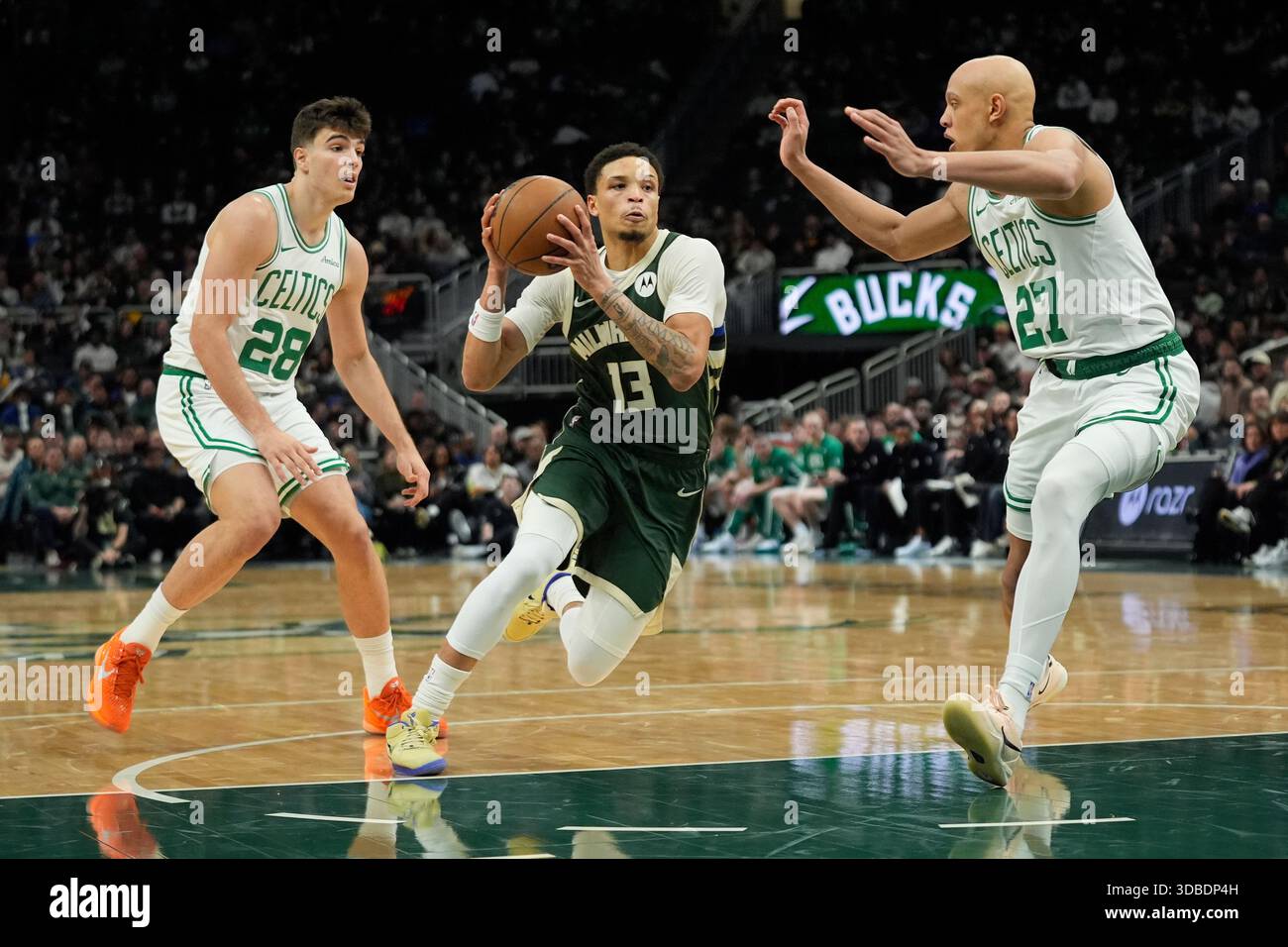 Milwaukee Bucks' Ryan Rollins drives to the basket between Boston ...