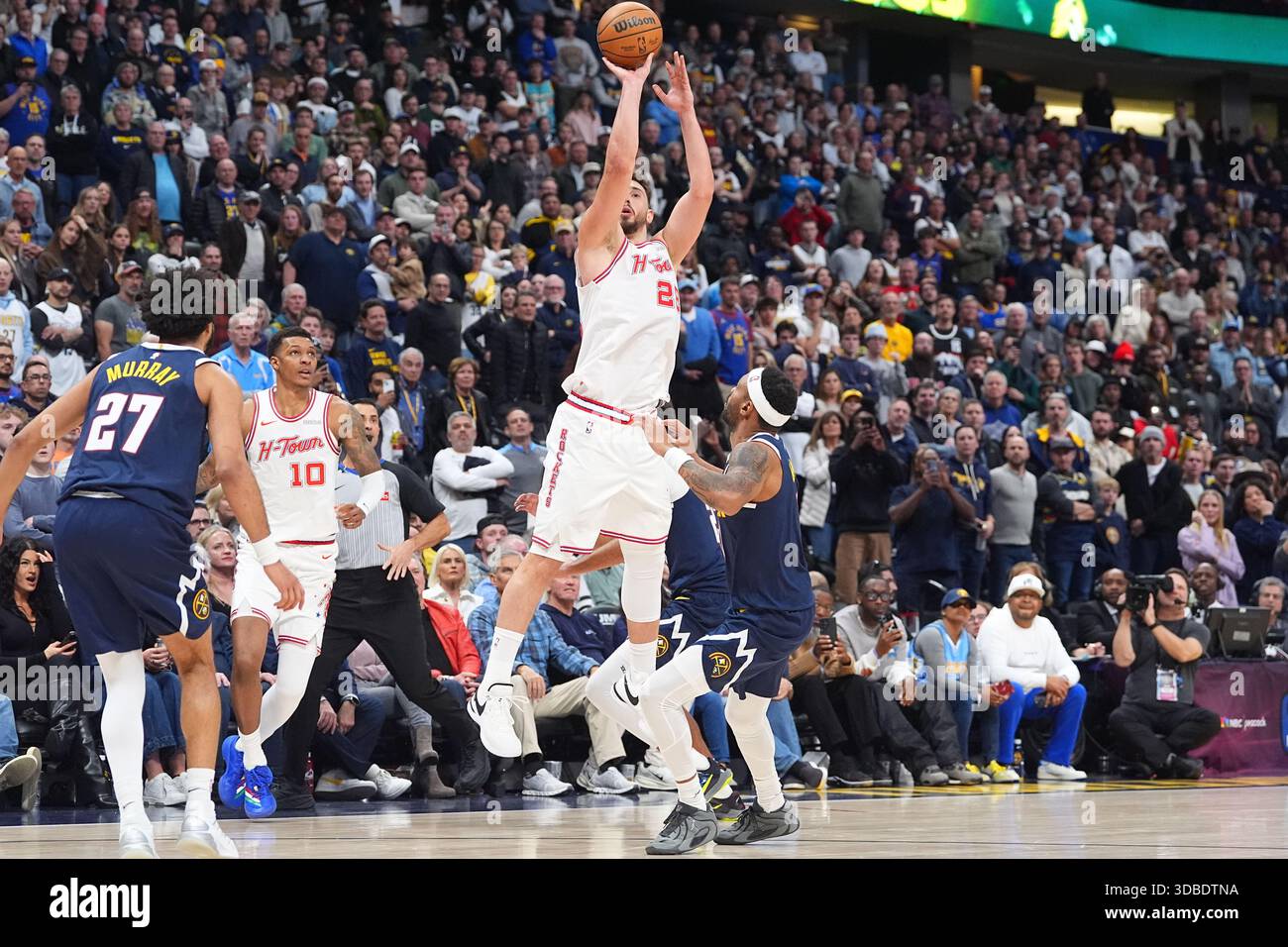 Houston Rockets center Alperen Sengun, back, shoots for a 3-point shot ...