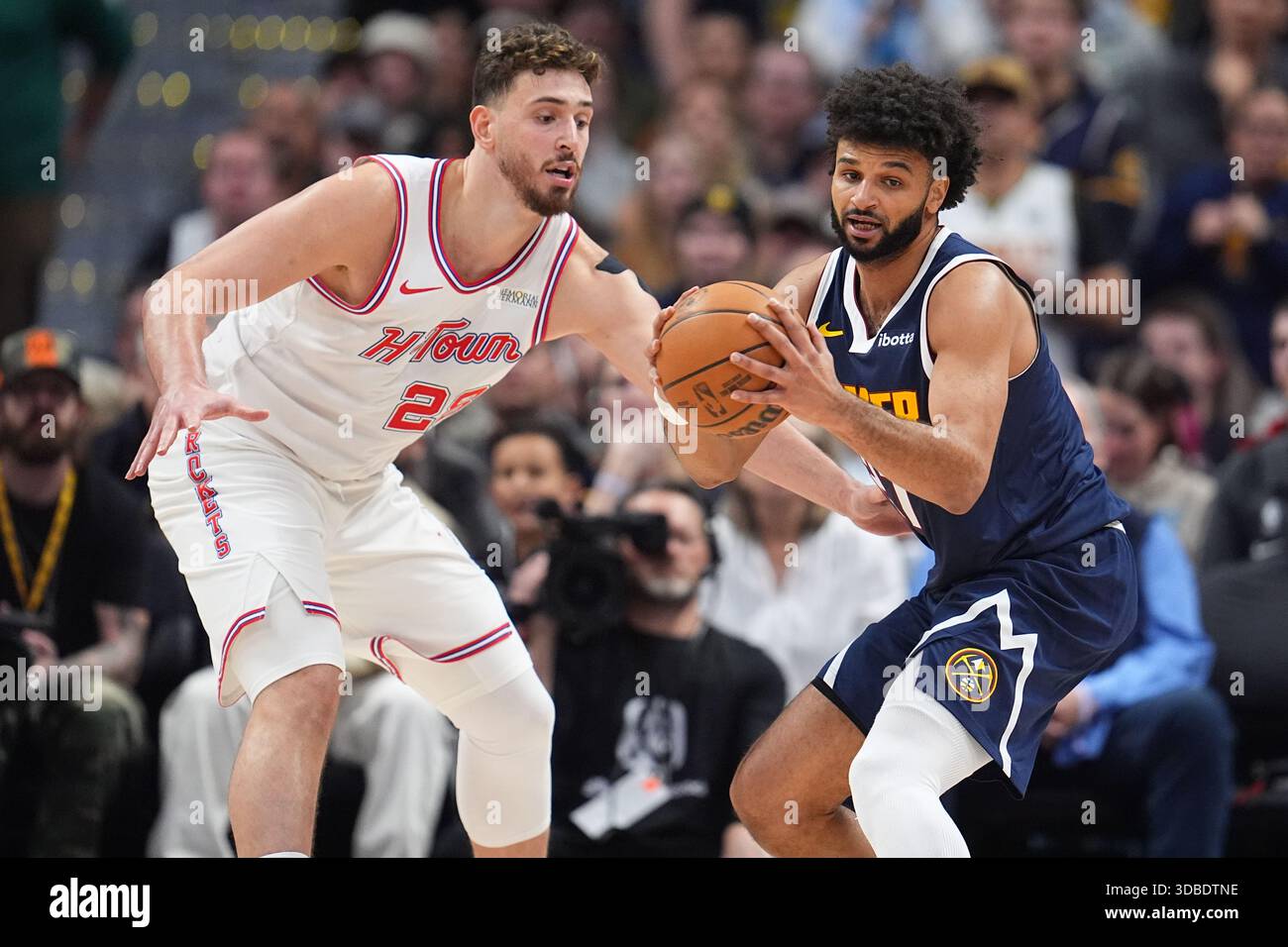 Denver Nuggets guard Jamal Murray, right, looks to pass the ball a ...