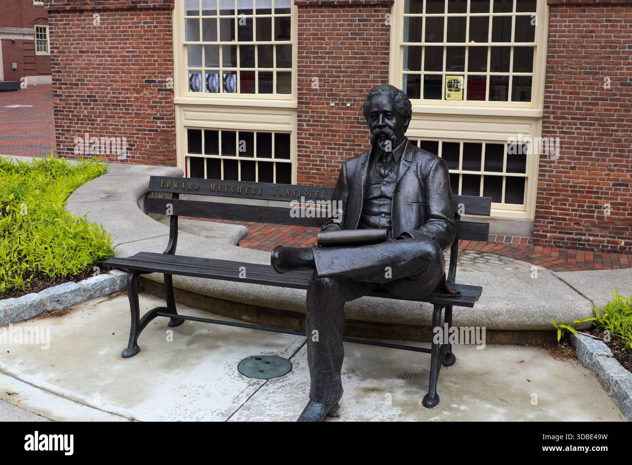 Bronze statue of Edward Mitchell Bannister seated on a bench near ...