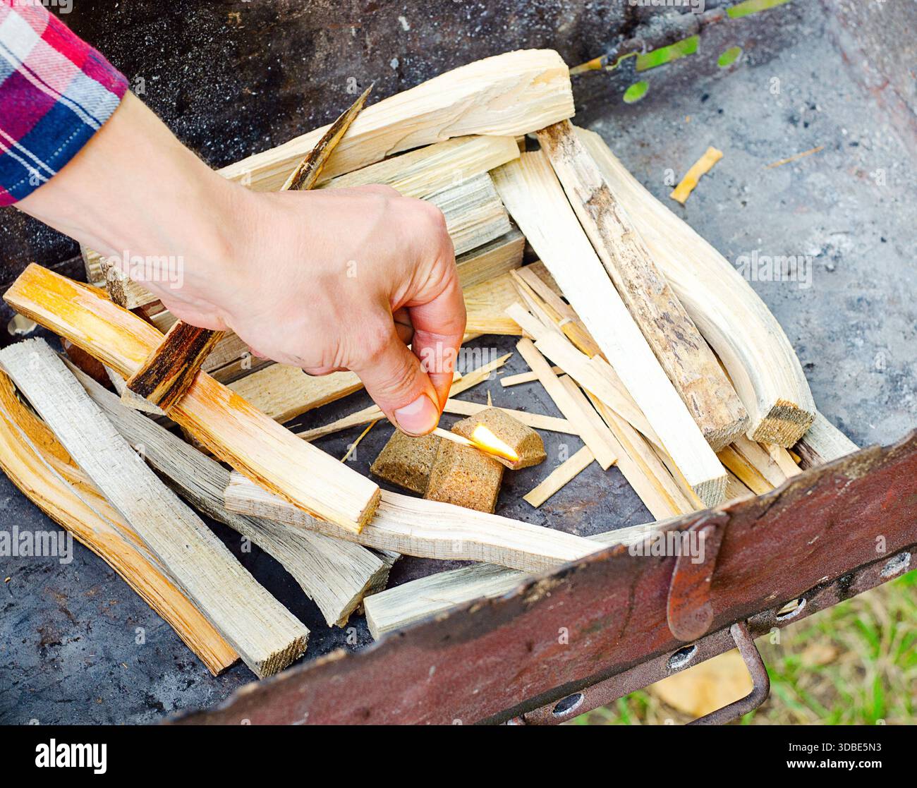 Hand lighting kindling fire hi-res stock photography and images - Alamy