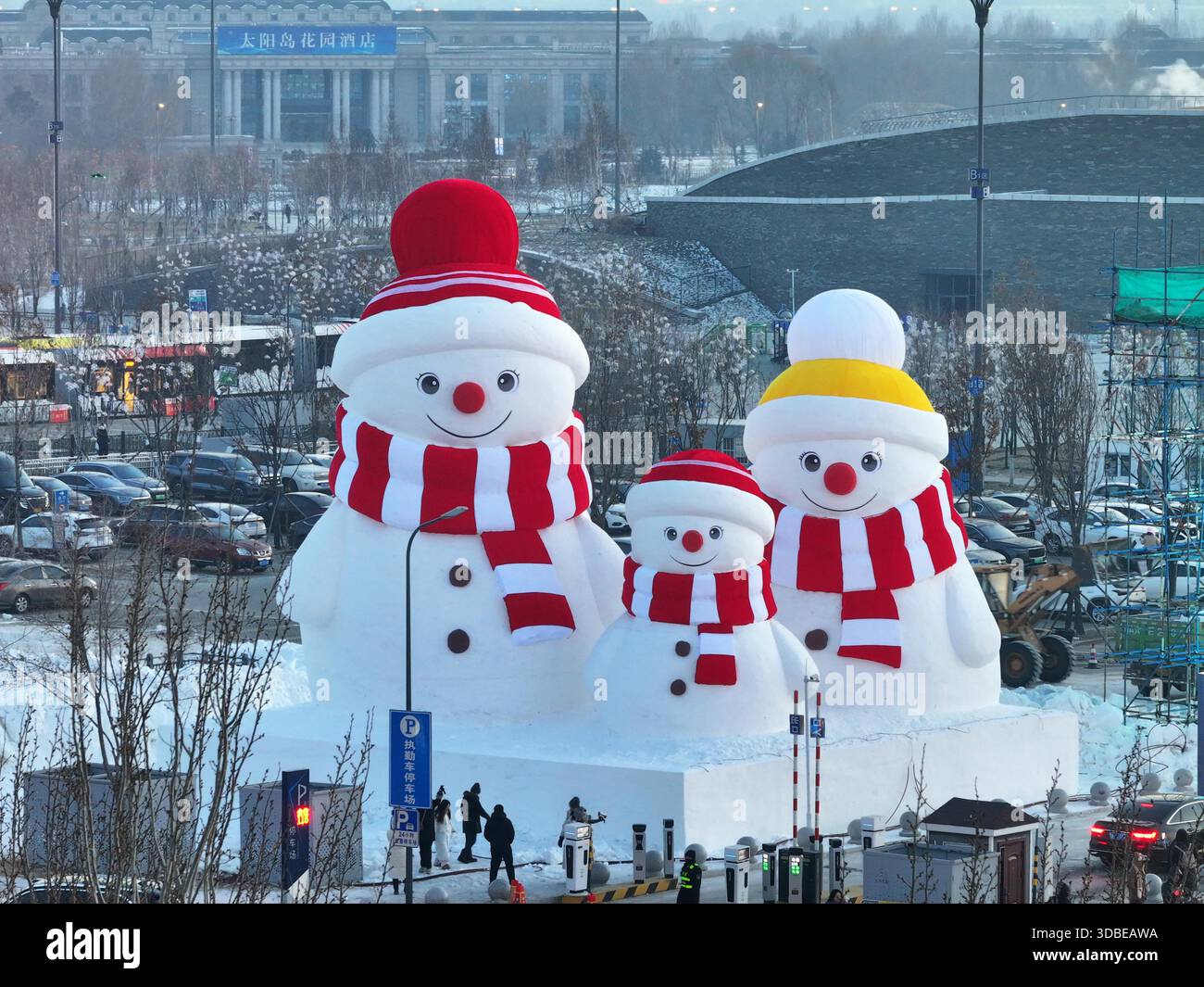 A group of snowman sculptures attract tourists at the 27th Harbin Ice ...