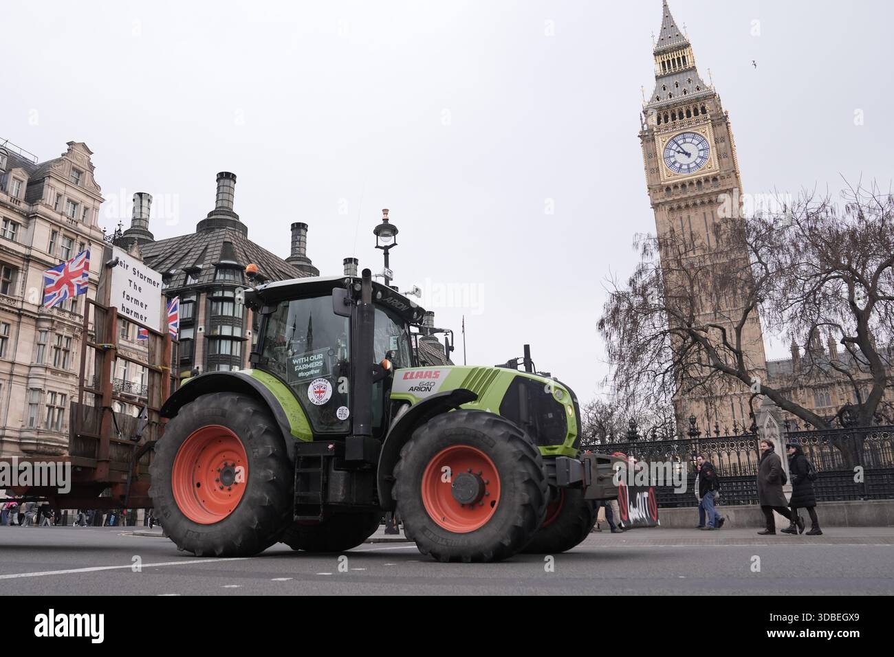 A tractor is driven through Parliament Square, past the Elizabeth Tower ...