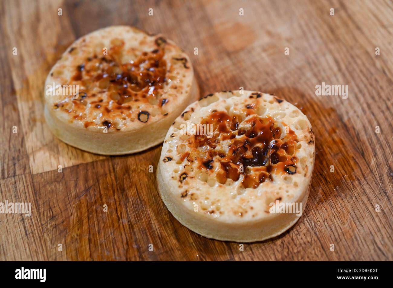 Hot toasted crumpets with butter and marmite for breakfast Stock Photo ...
