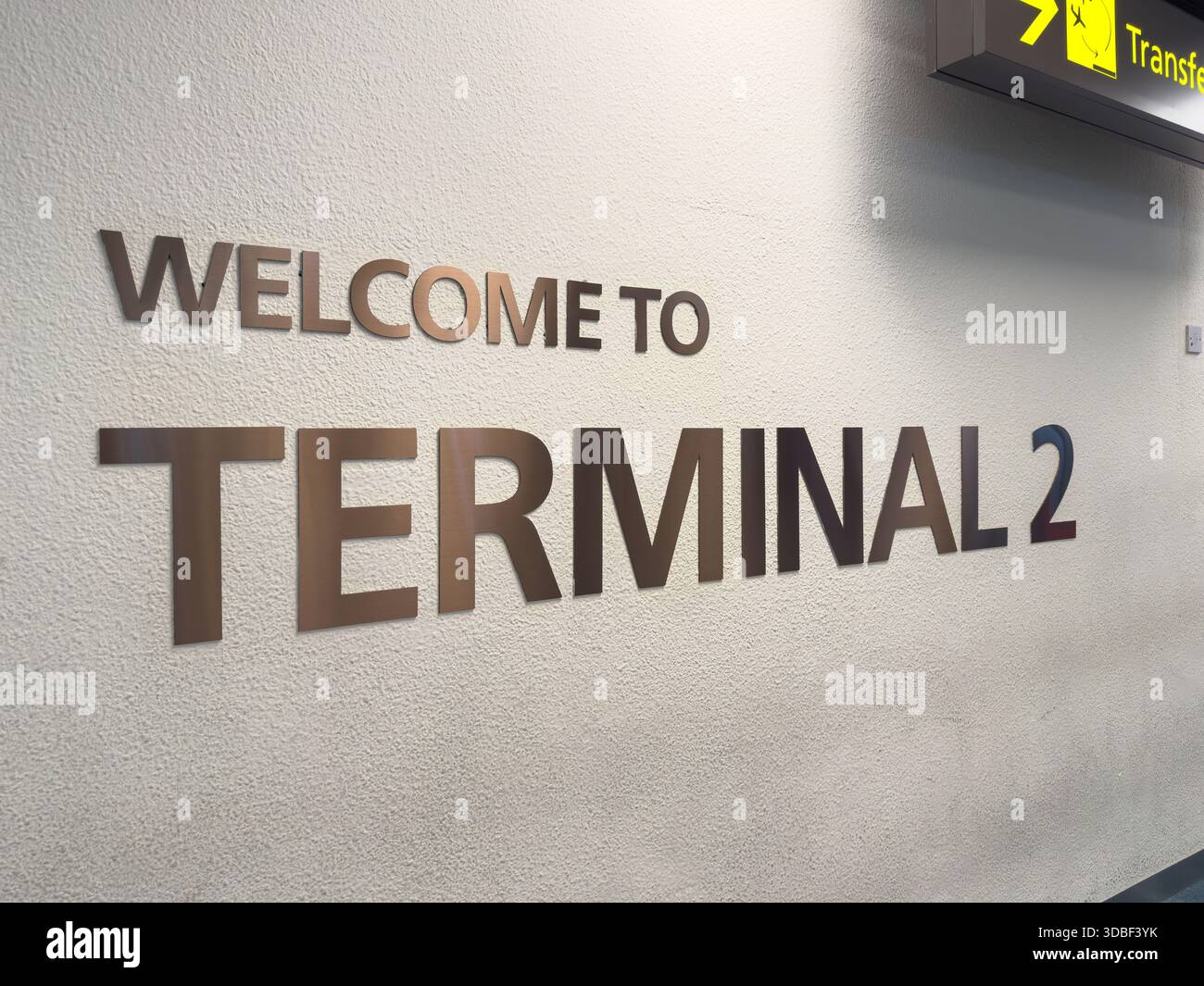 The wall displays WELCOME TO TERMINAL 2 at Singapore Changi Airport ...