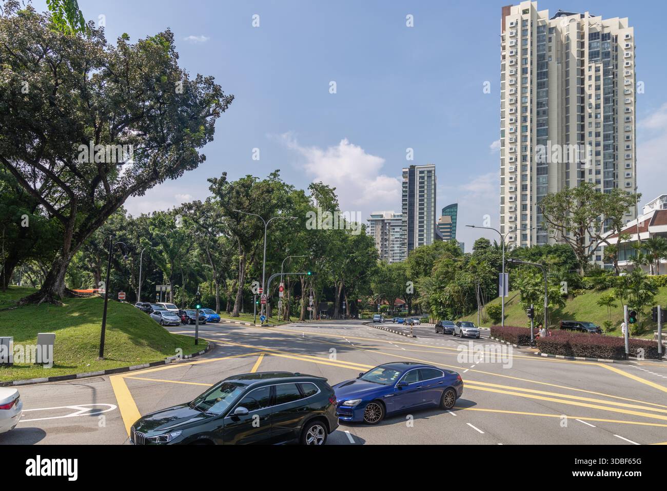 Modern Singapore city intersection bustling with cars under bright ...