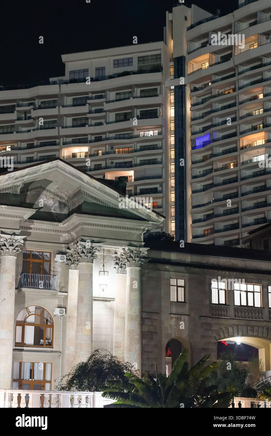 Night scene showing ornate neoclassical portico in foreground with tall ...