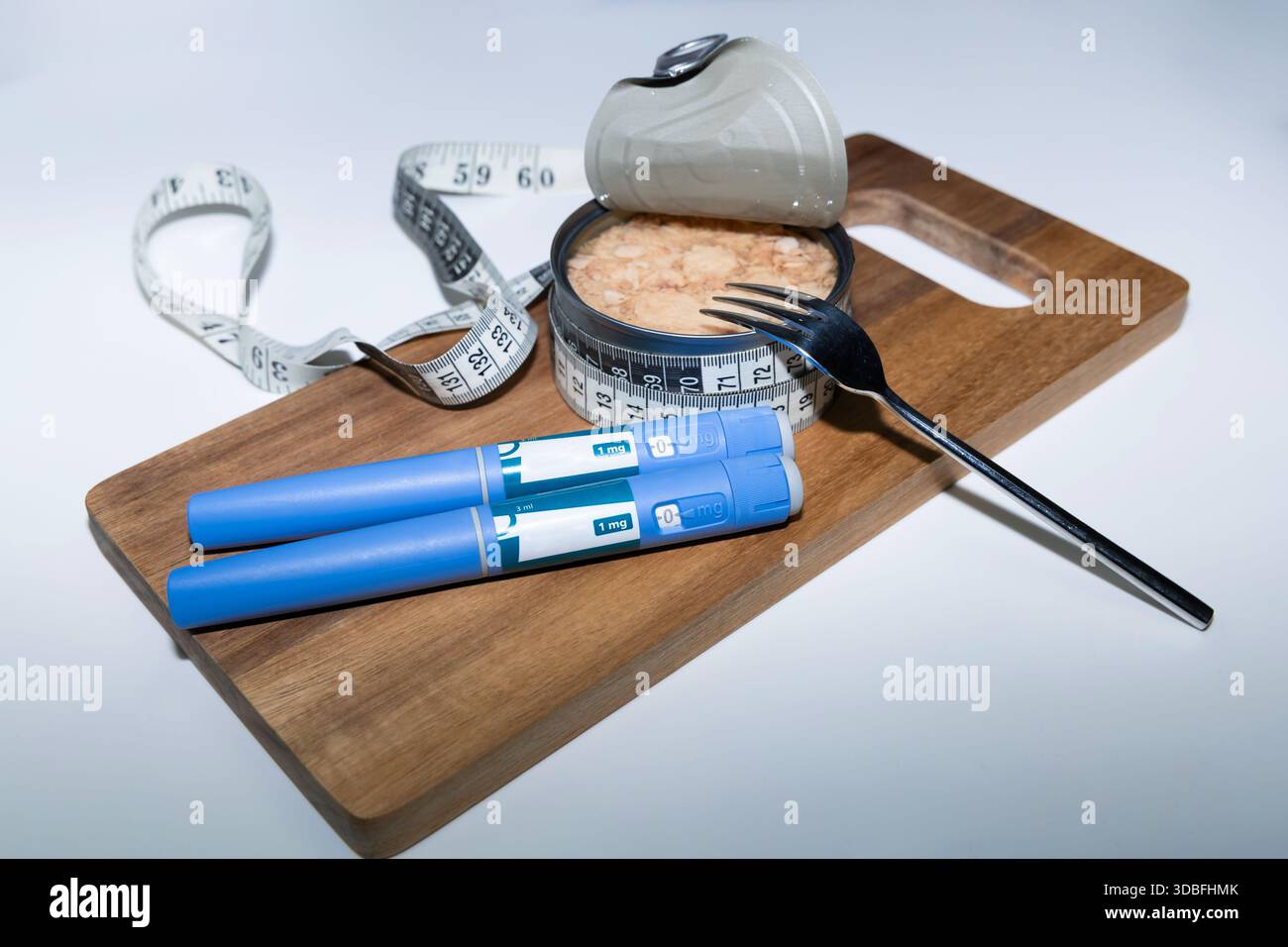 Healthy diet concept with tuna can and ozempic pen Stock Photo - Alamy