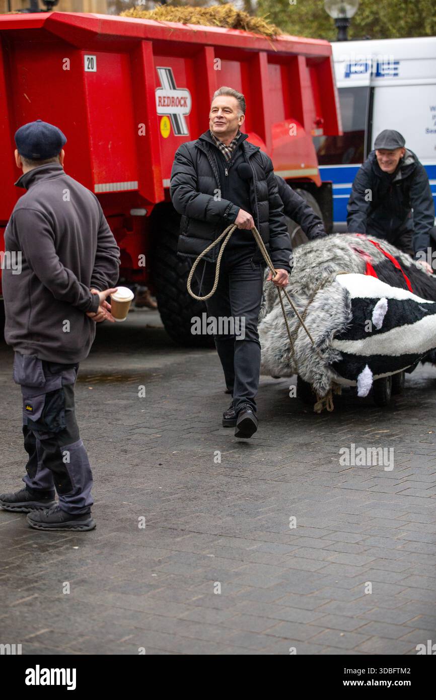 London, UK. 16th Dec, 2025. Chris Peckham pushed a giant model badger ...