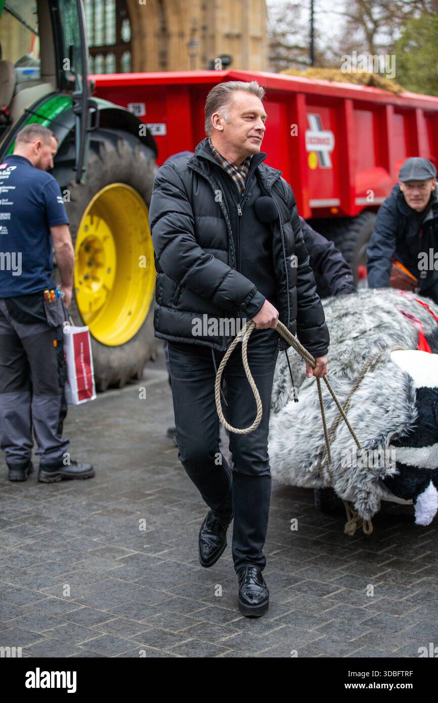 London, UK. 16th Dec 2025. Chris Peckham pushed a giant model badger ...