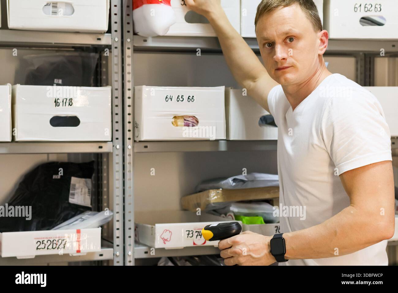 Male scanning item in distribution hi-res stock photography and images ...