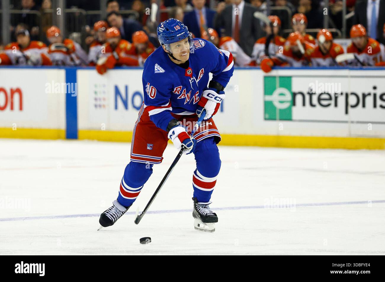 New York Rangers left wing Artemi Panarin skates with the puck during ...