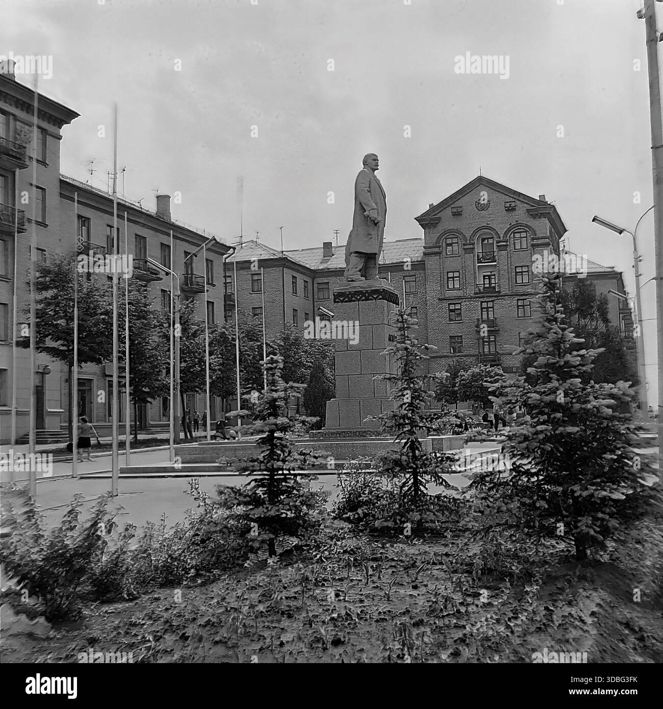 Black and white archival photo capturing a central city square with a ...