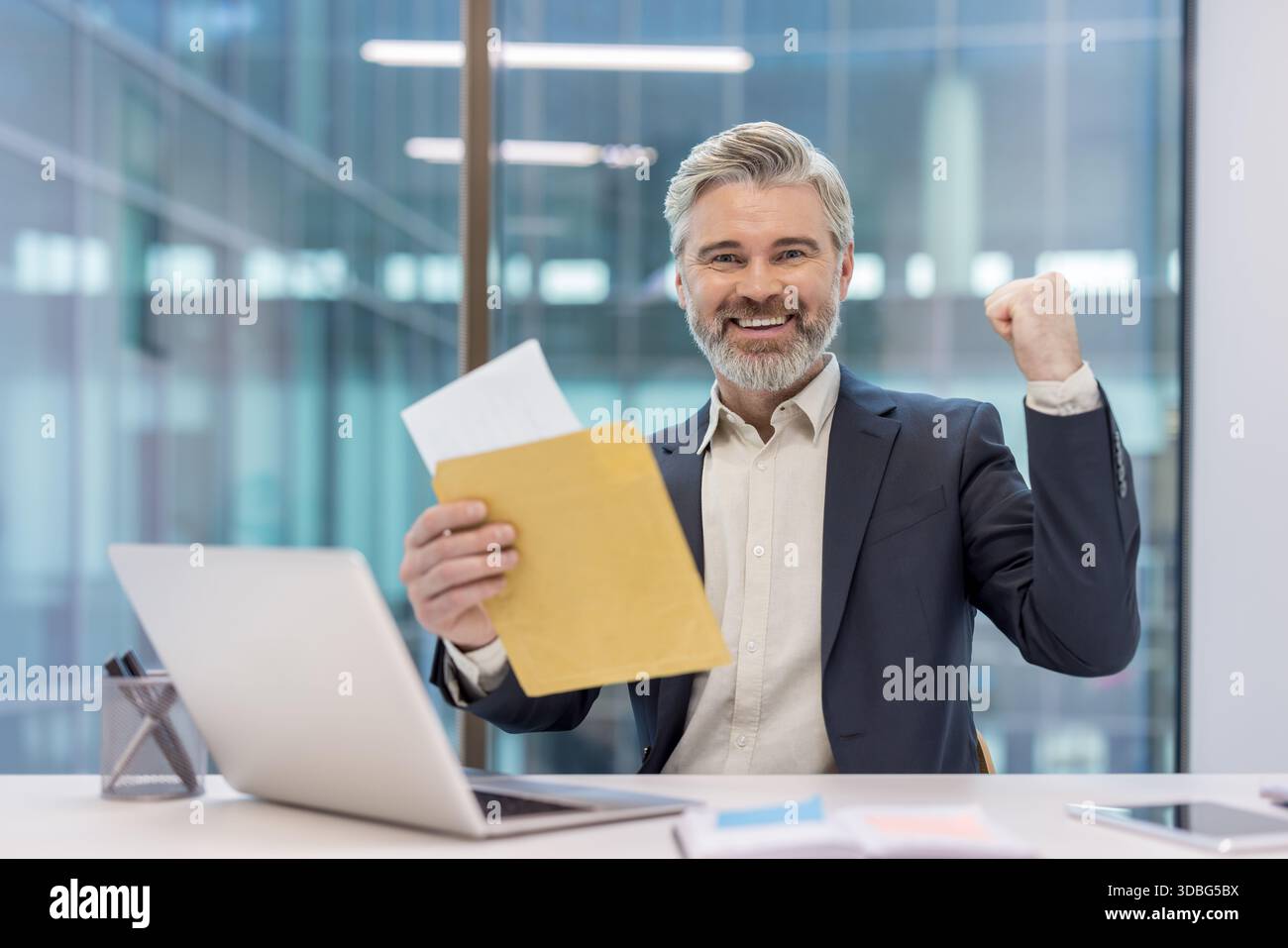 Businessman expressing joy and celebrating success after opening an ...