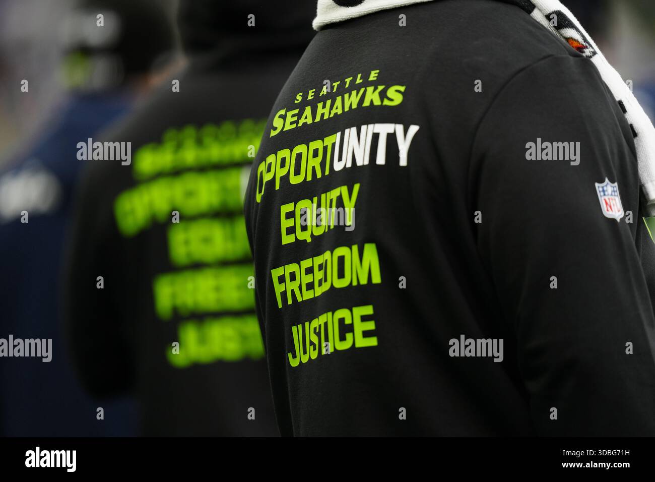 A Seattle Seahawks assistant coach wears an Inspire Change hoodie ...