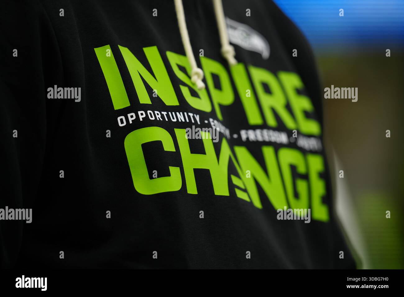 A Seattle Seahawks assistant coach wears an Inspire Change hoodie ...