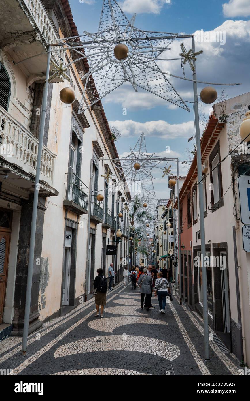 Narrow pedestrian street in Funchal, Madeira, shows star lights and ...