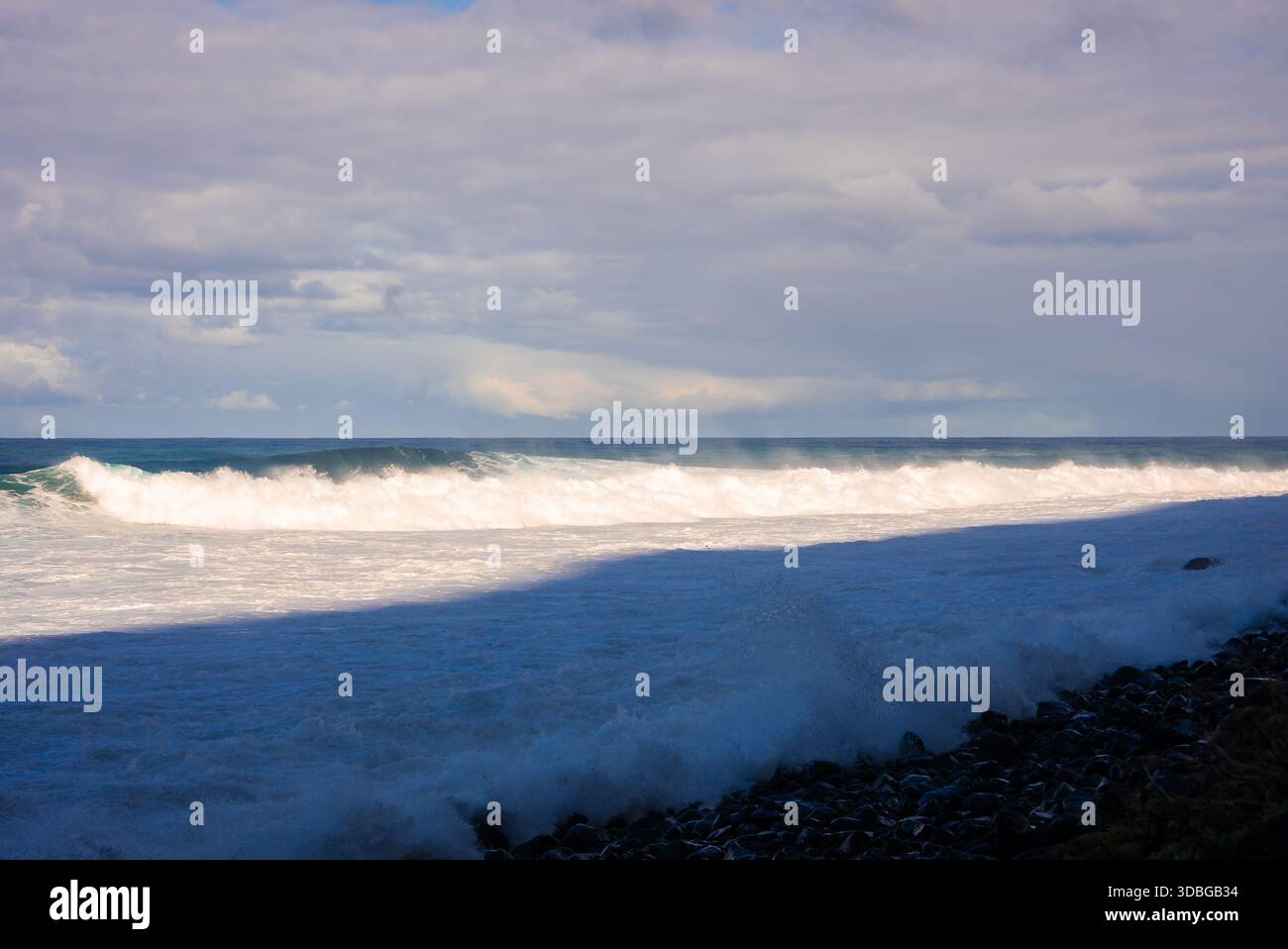 Atlantic swells crash on pebble shore in Madeira, Portugal winter Stock ...