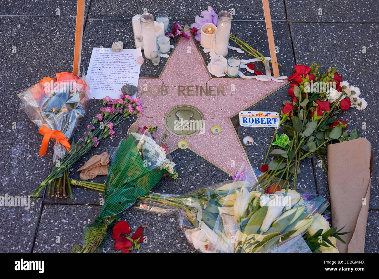 Flowers and candles are placed on the Walk of Fame star for Rob Reiner ...