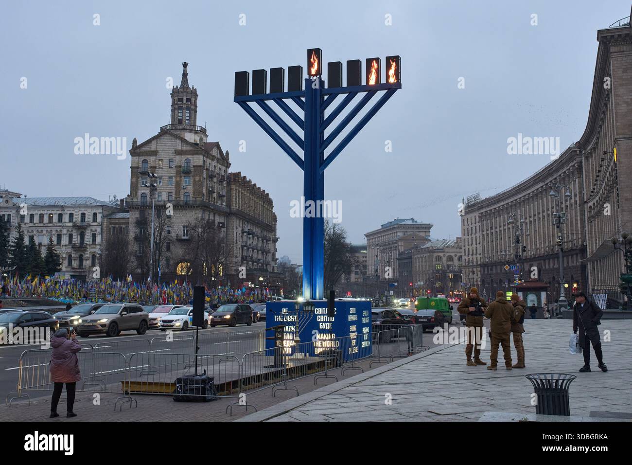 People pass by a menorah to celebrate Hanukkah in Independence Square ...