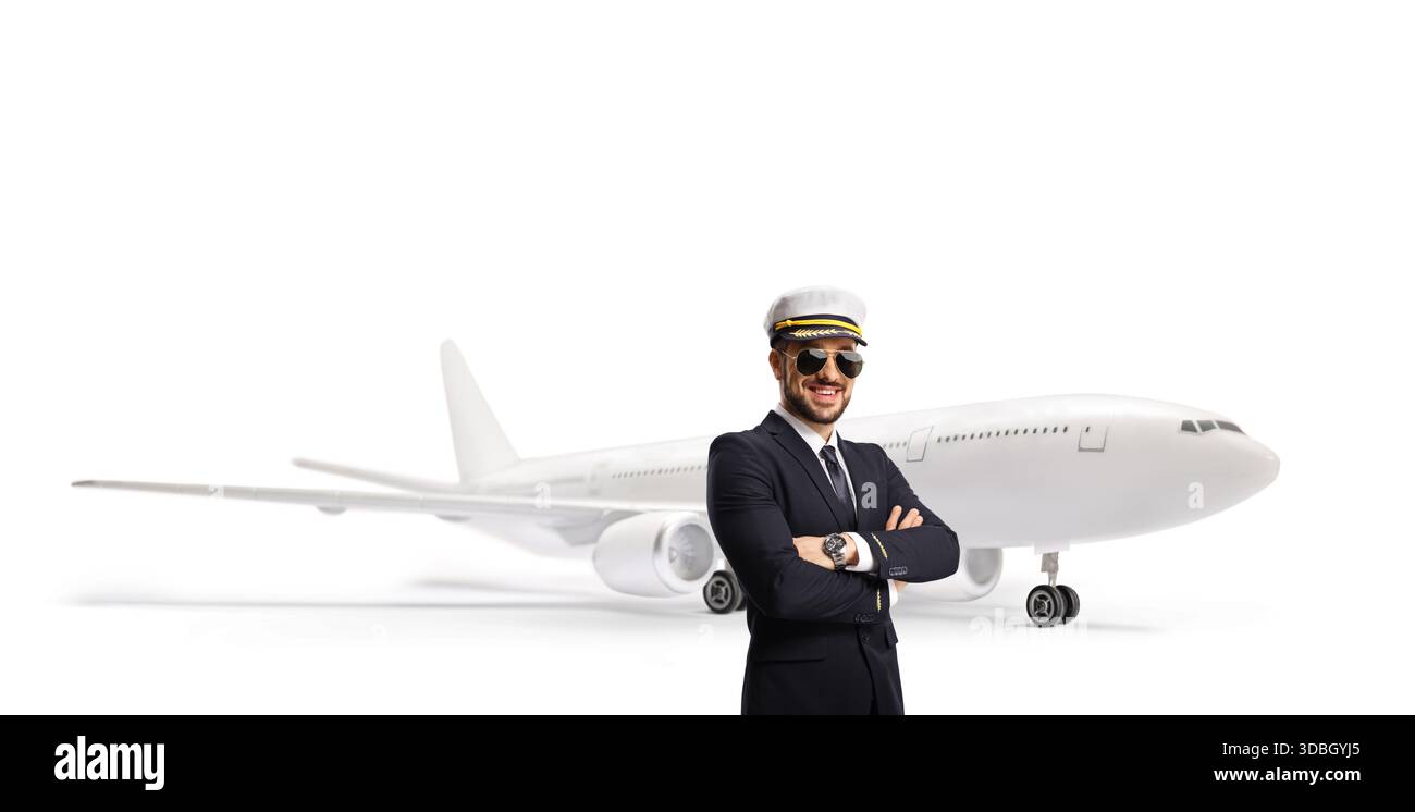 Pilot in a uniform standing in front of an aircraft isolated on white ...